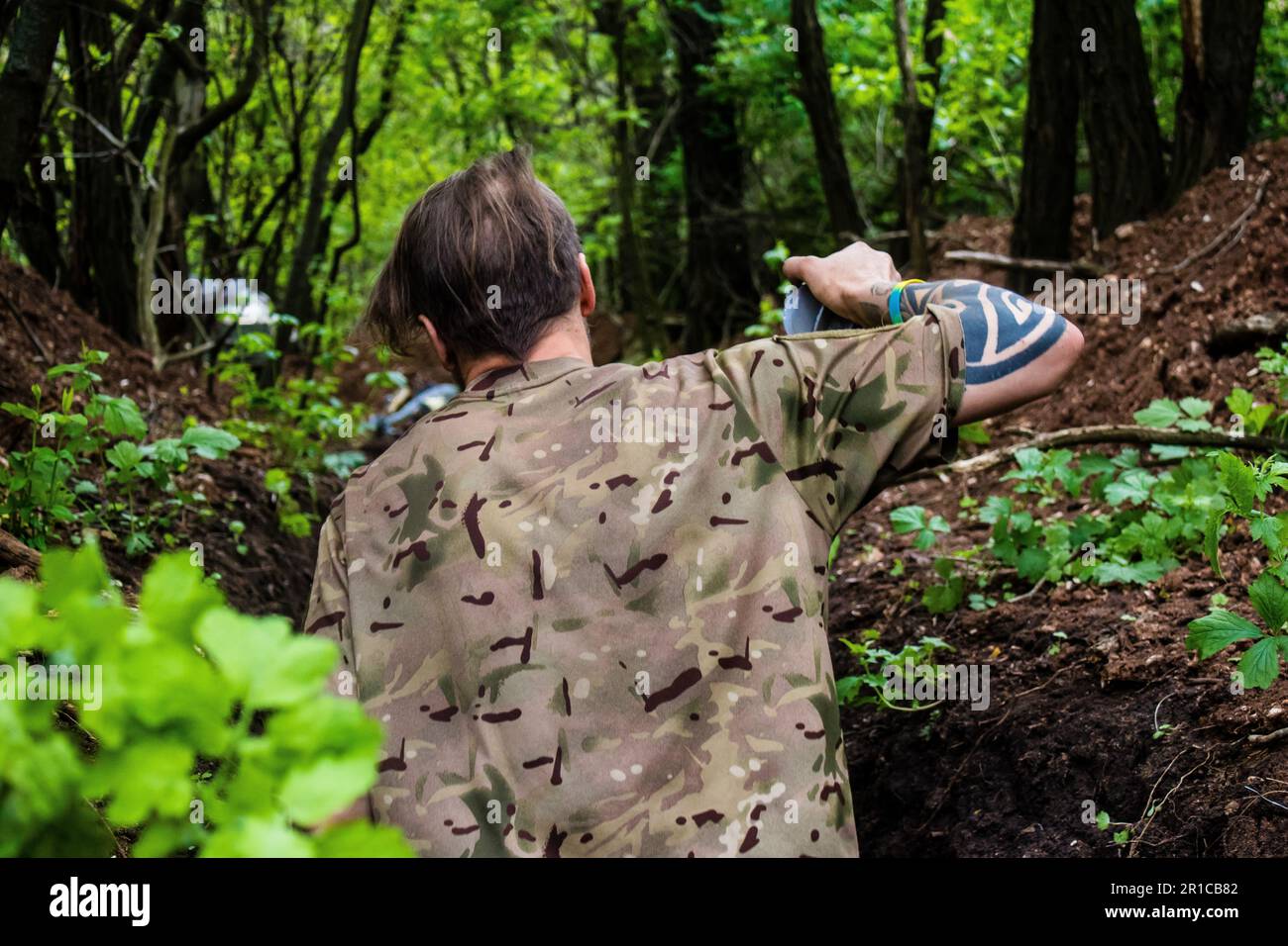 Ukrainian soldier from the 28th Artillery Battalion carrying a shell of ...
