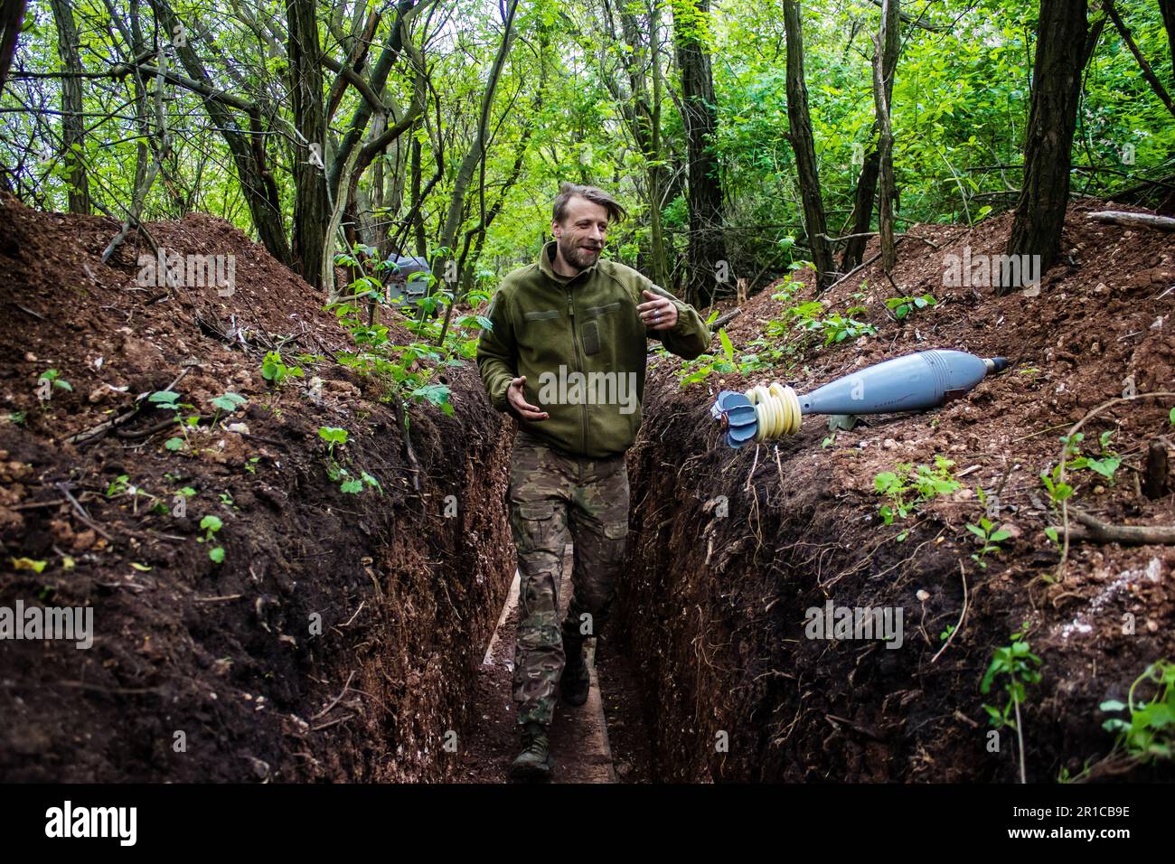 Ukrainian soldier from the 28th Artillery Battalion carrying a shell of ...