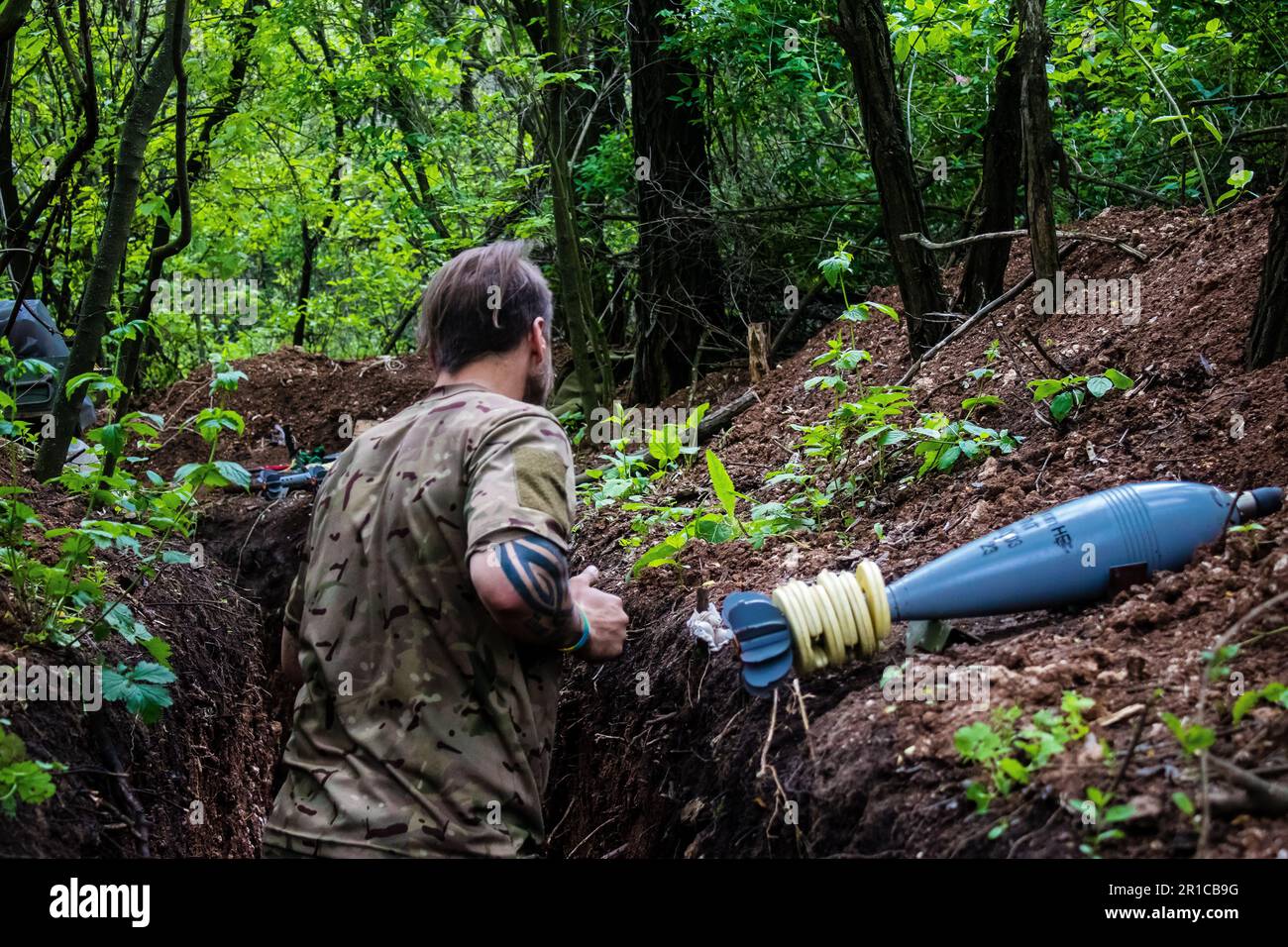 Ukrainian soldier from the 28th Artillery Battalion carrying a shell of ...