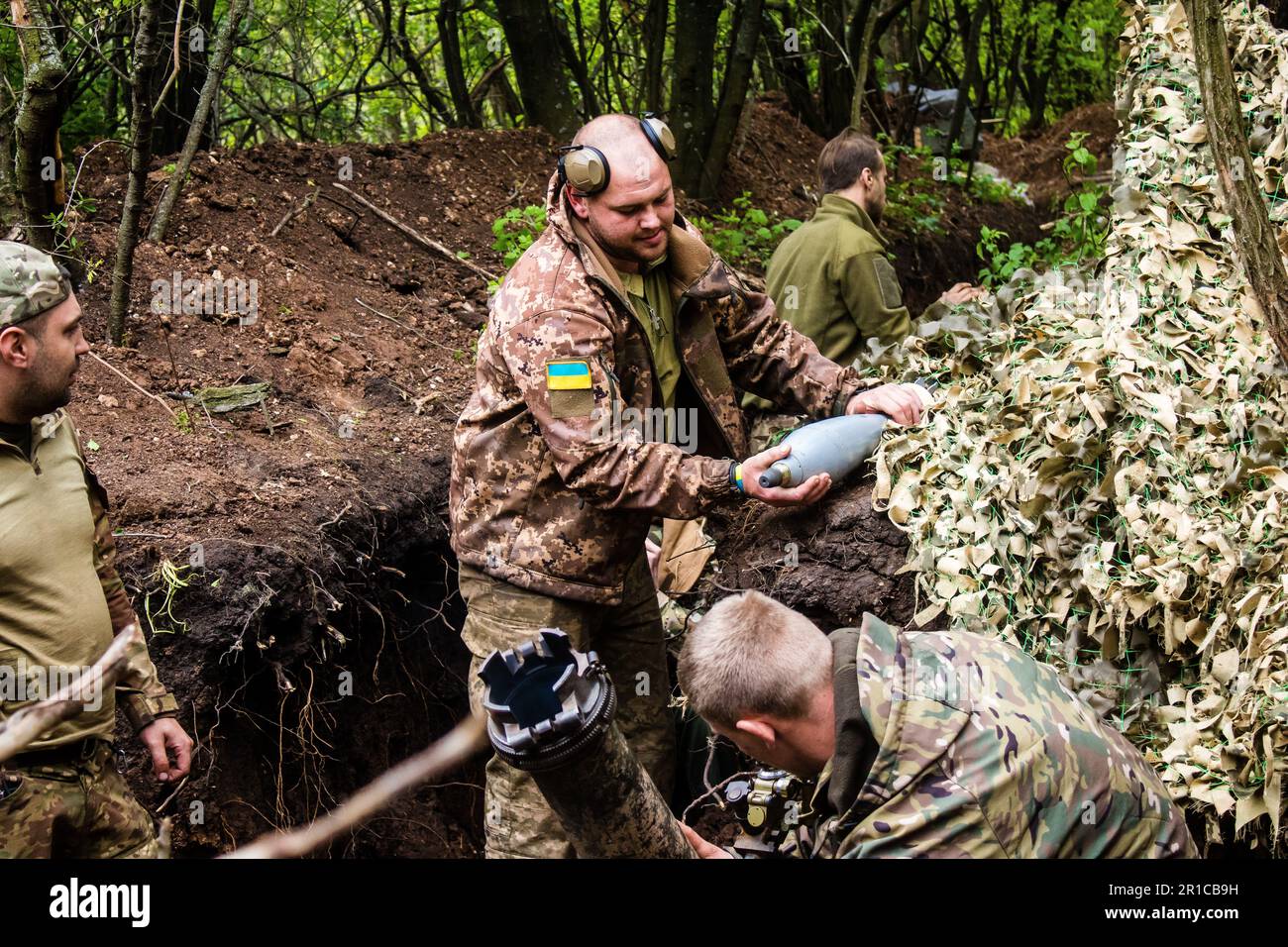 Ukrainian soldier from the 28th Artillery Battalion carrying a shell of ...