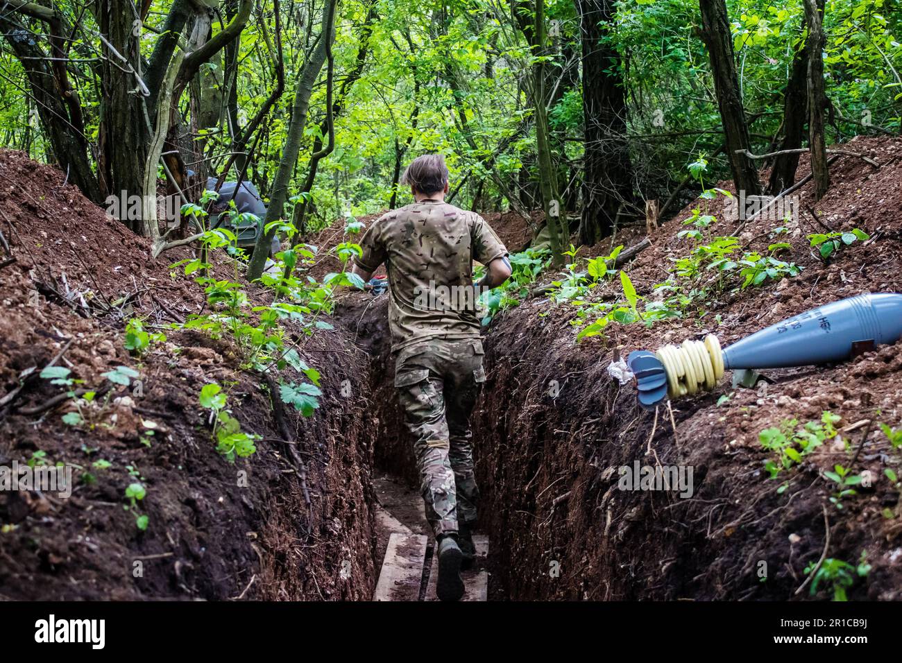Ukrainian soldier from the 28th Artillery Battalion carrying a shell of ...
