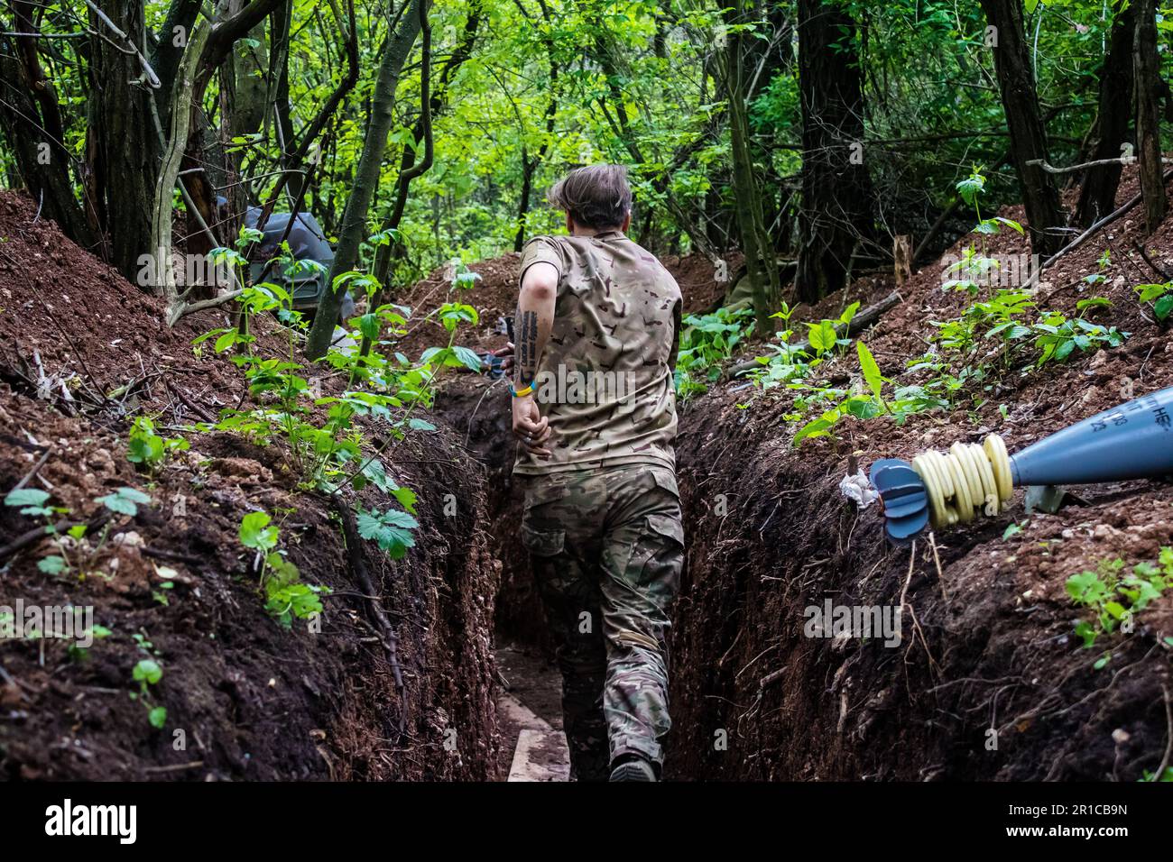 Ukrainian soldier from the 28th Artillery Battalion carrying a shell of ...