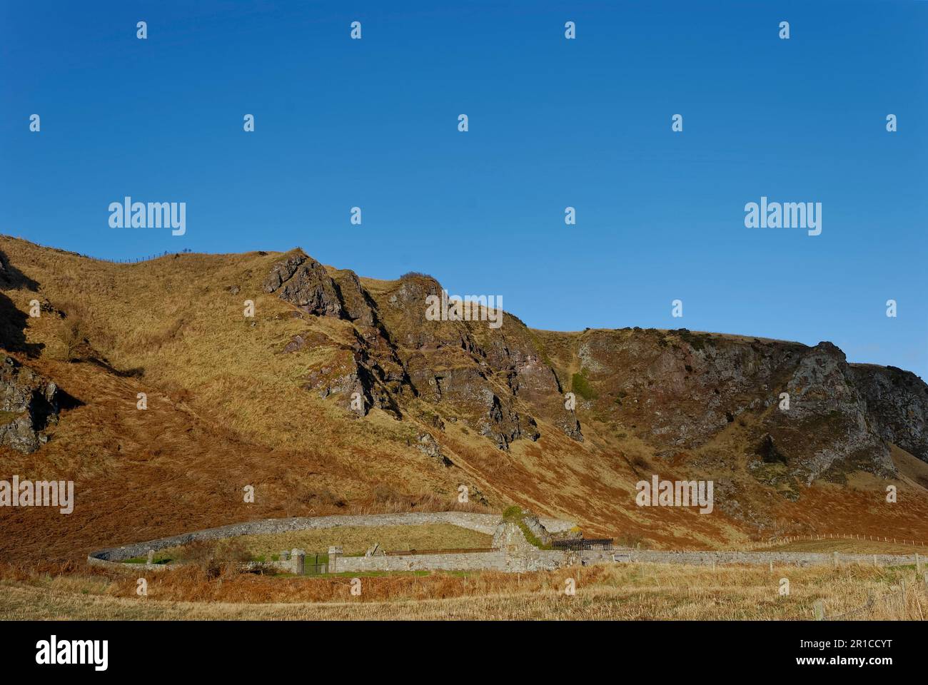The Ecclesgreig Burial Ground beneath the dramatic Volcanic Cliffs at ...