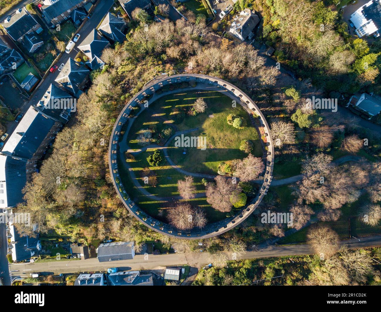 A bird's-eye view of a lush, circular park surrounded by a ring of ...