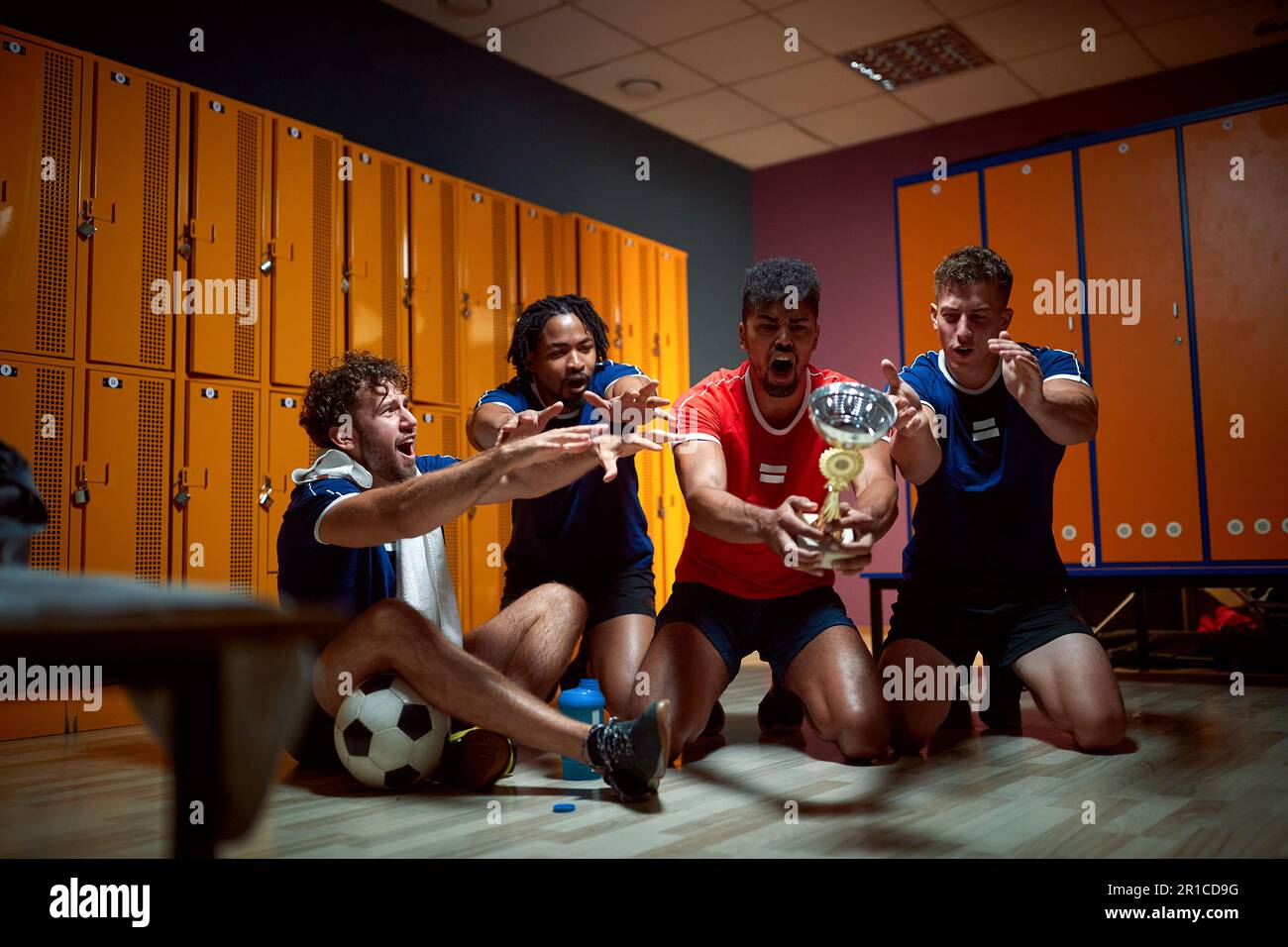Team of young football players celebrating first place win together in ...