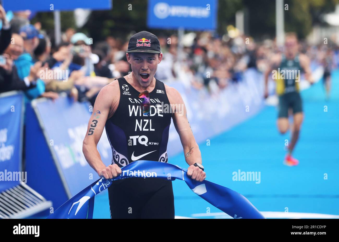 Hayden Wilde of New Zealand, winner, crosses the finish line during ...
