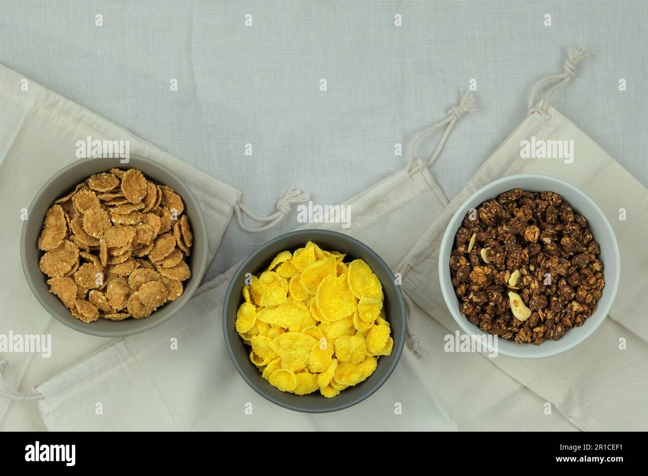 Variety of breakfast cereals in bowls on a light wooden background ...