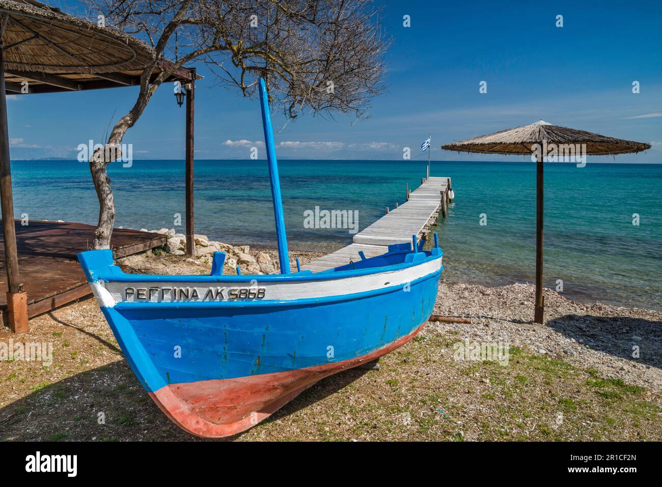 Boat on beach in village of Boukari, Corfu Island, Greece Stock Photo ...