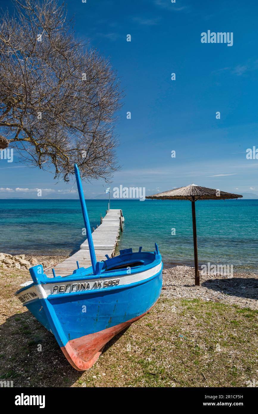 Boat on beach in village of Boukari, Corfu Island, Greece Stock Photo ...