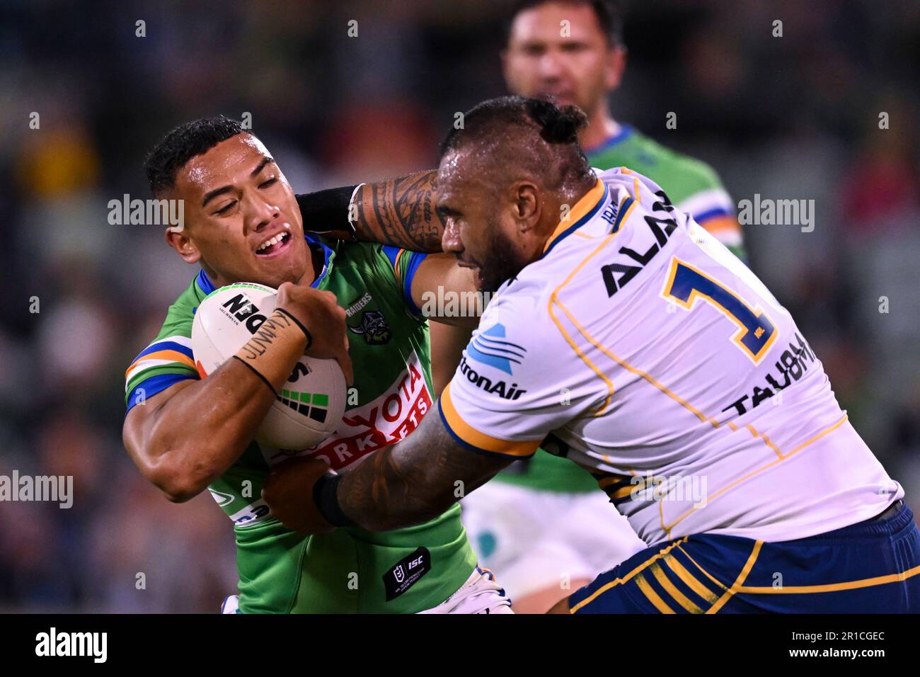 Albert Hopoate of the Raiders is tackled by Junior Paulo of the Eels ...