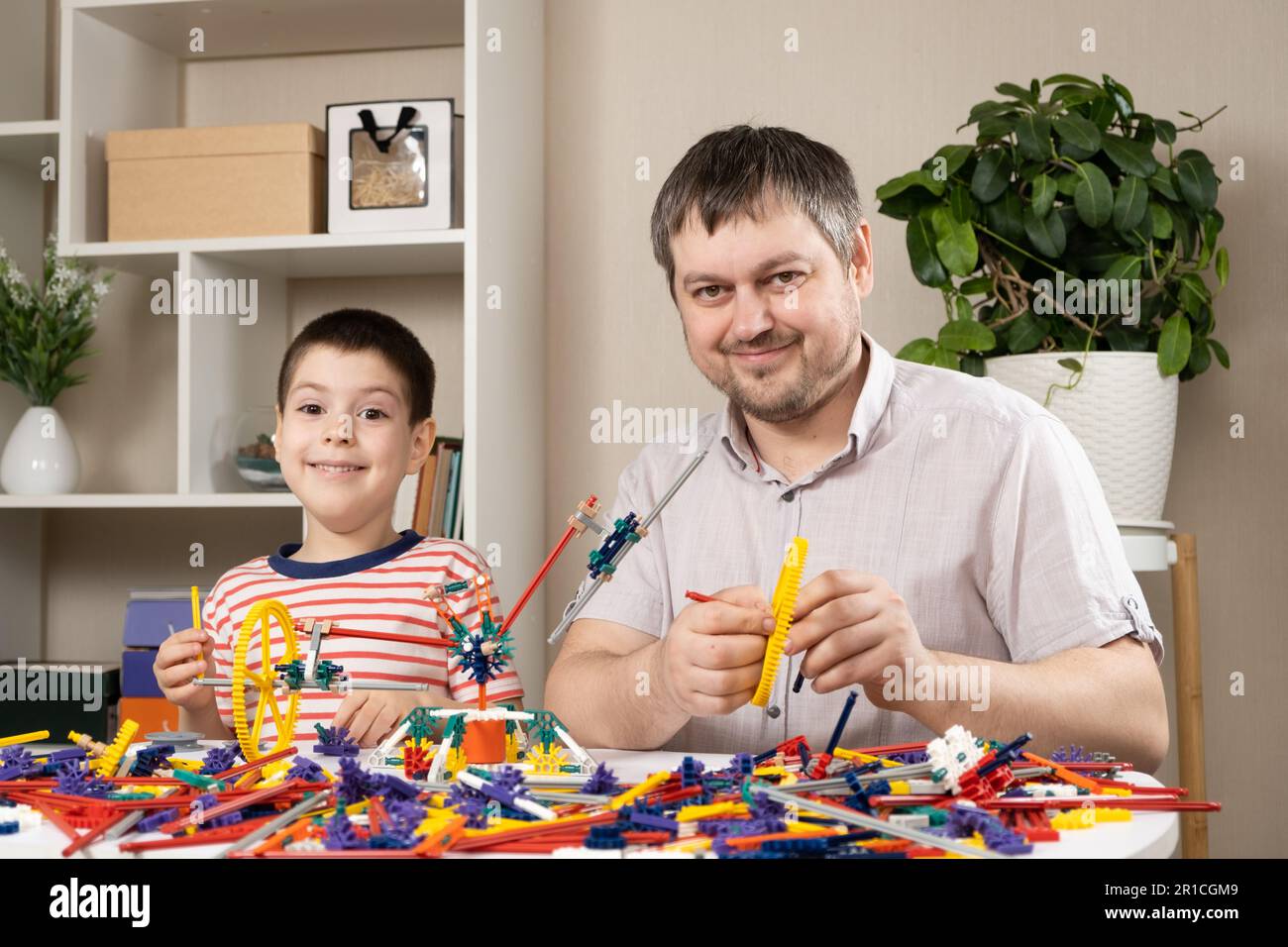 Dad and son build figures from the constructor. Spending time together ...