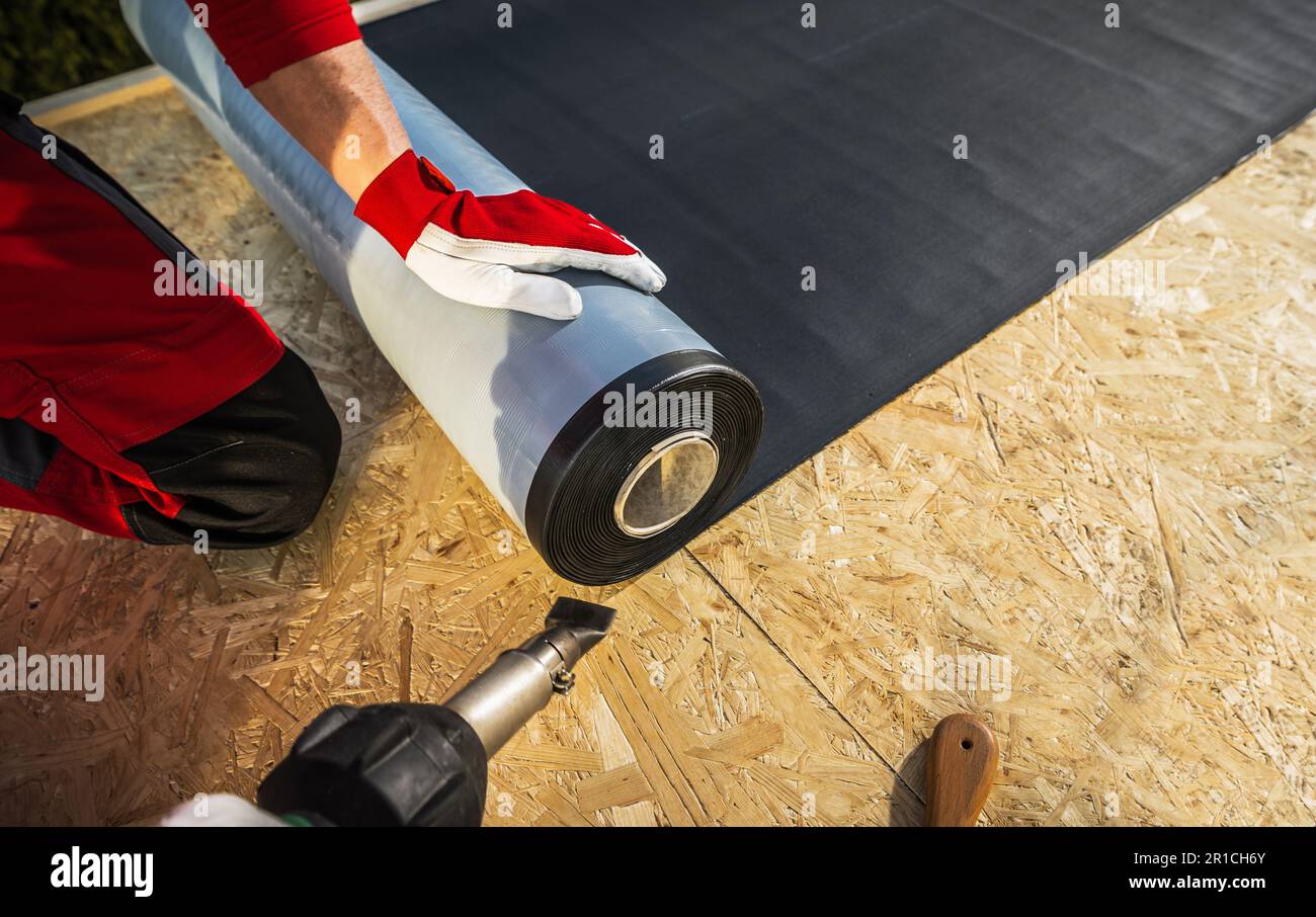 Roof Worker with Roll of EPDM Rubber Membrane Material Preparing to ...