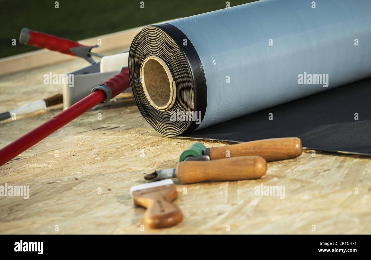 Roll of Modern EPDM Roofing Rubber Material and Some Tools. Roof Job ...