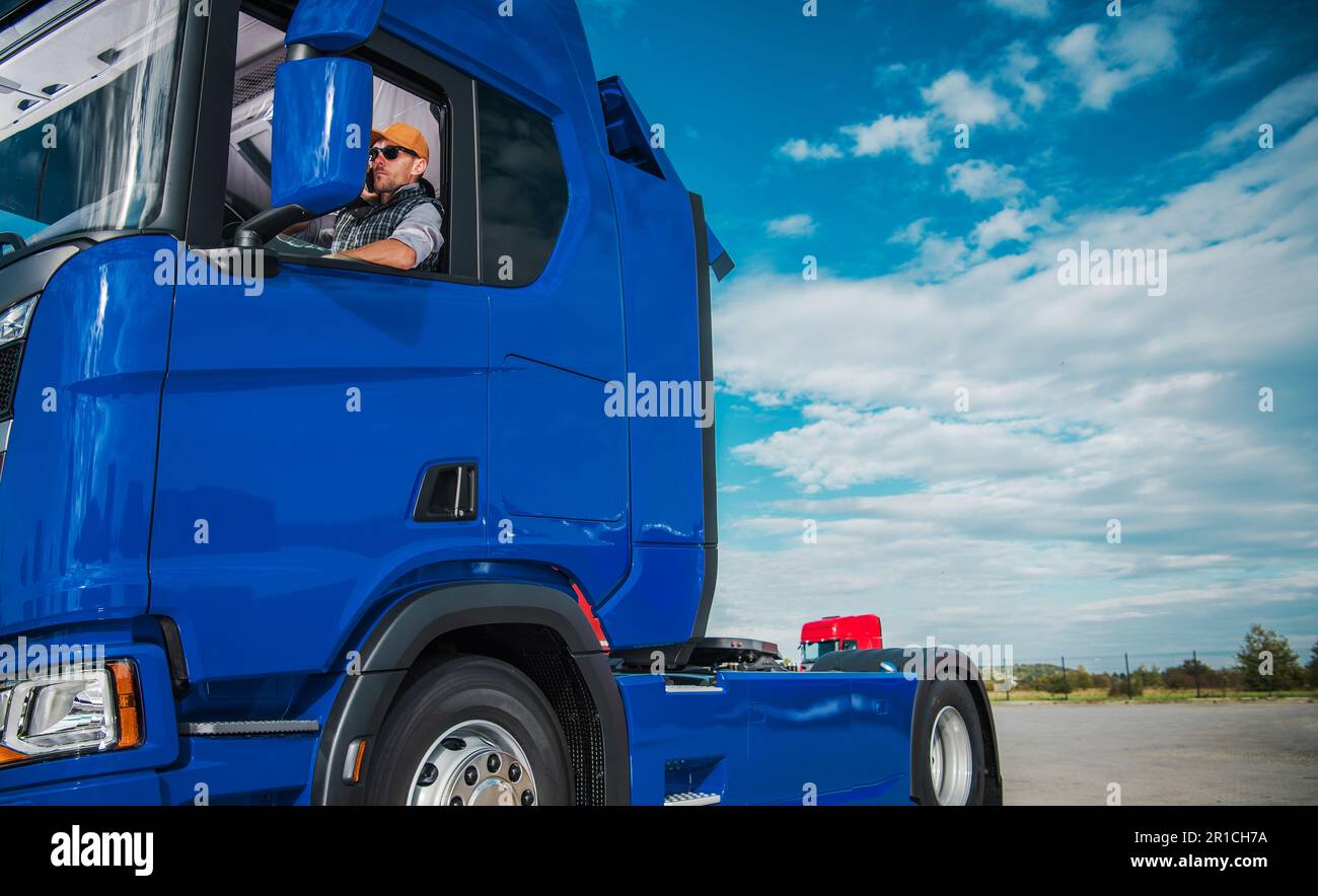 Caucasian Semi Truck Driver Awaiting a Trailer with Shipping Cargo ...