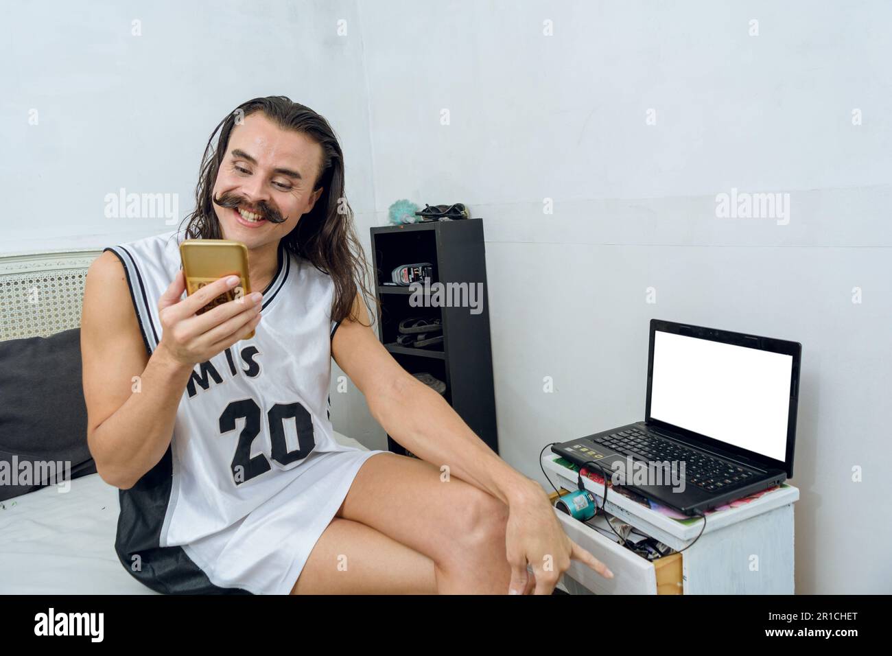 young latin person of non-binary gender with mustache and long hair ...