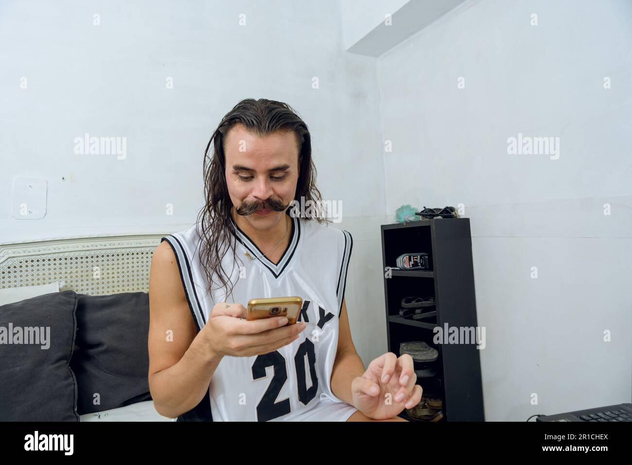 Latino young person of non-binary gender, with long hair and mustache ...