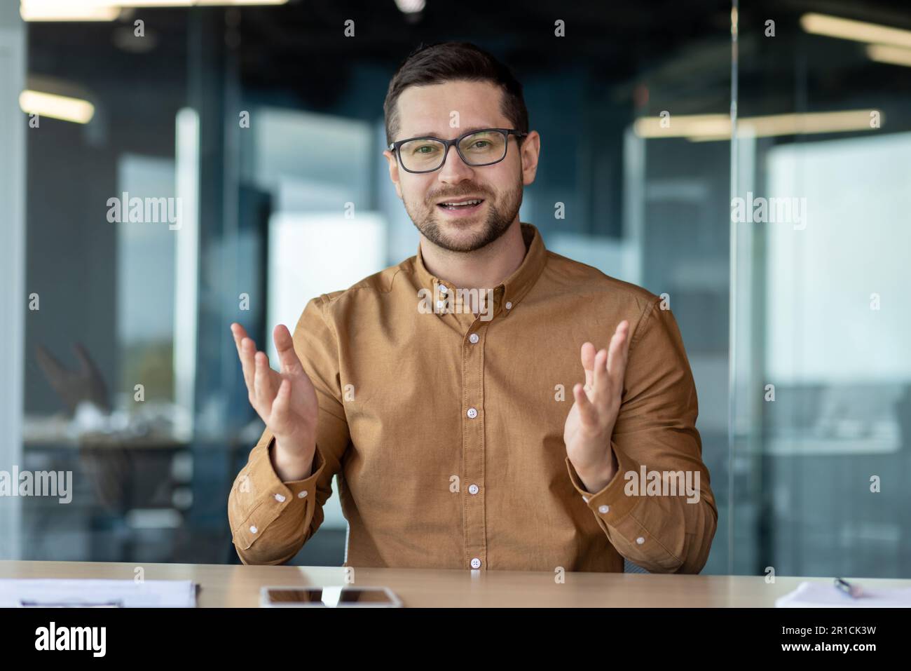 Distance Learning. Smiling young male teacher, tutor, trainer sitting ...