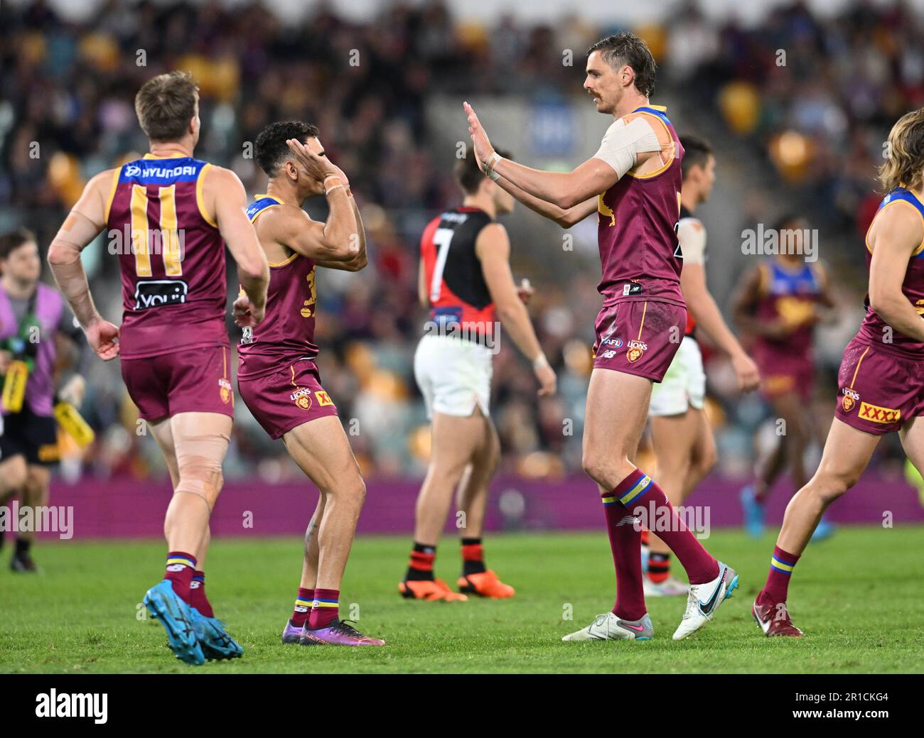 Joe Daniher (right) of the Lions celebrates kicking a goal with Charlie ...