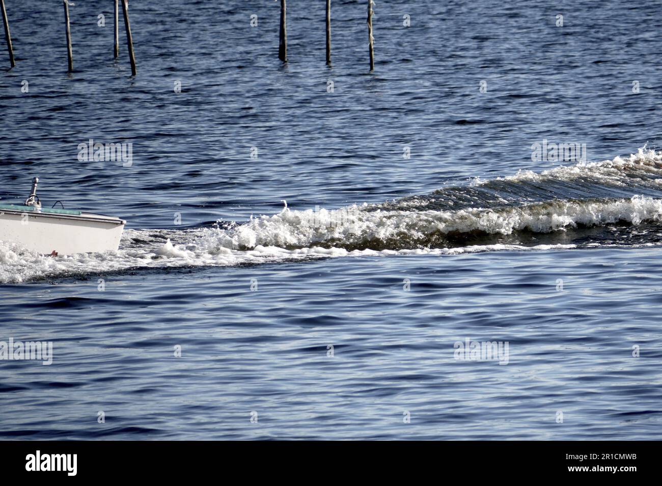 stern wave of a small boat on a lake Stock Photo - Alamy