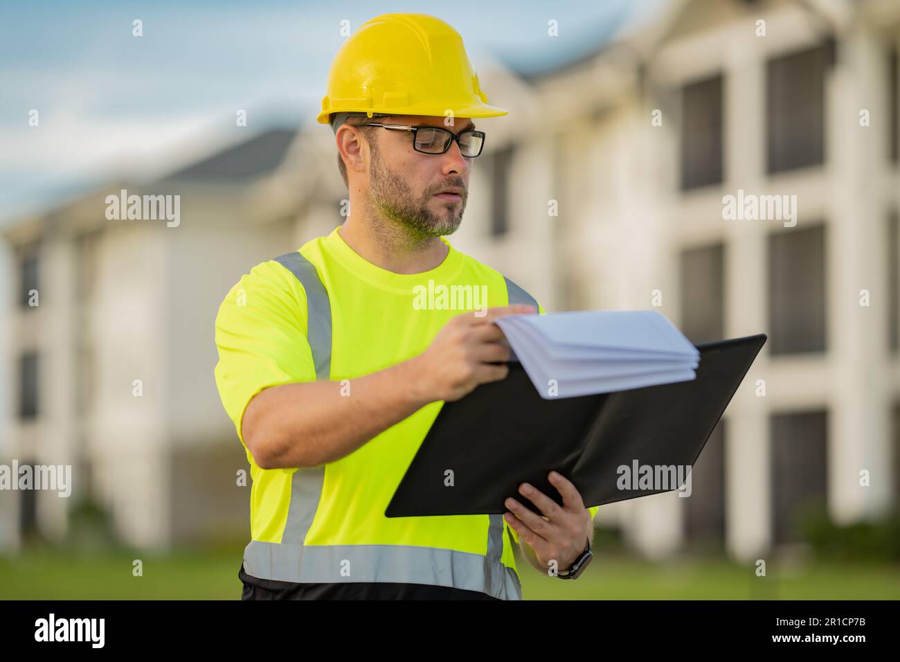Builder on site construction. Man worker in hard hat. Engineer with ...