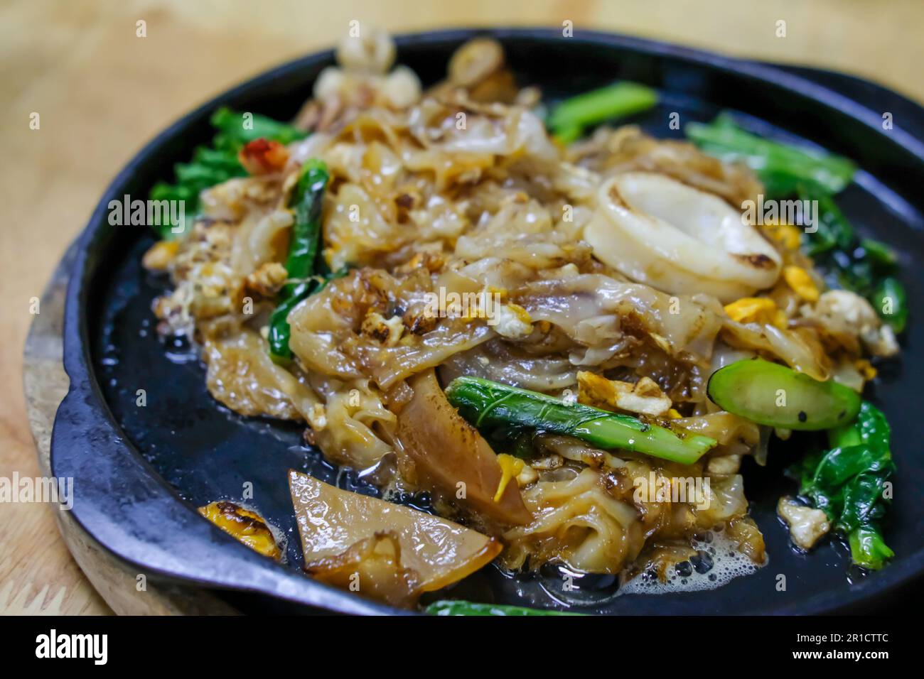 Pad see ew, Stir-fried noodles with soy sauce served on pan. Thai style ...