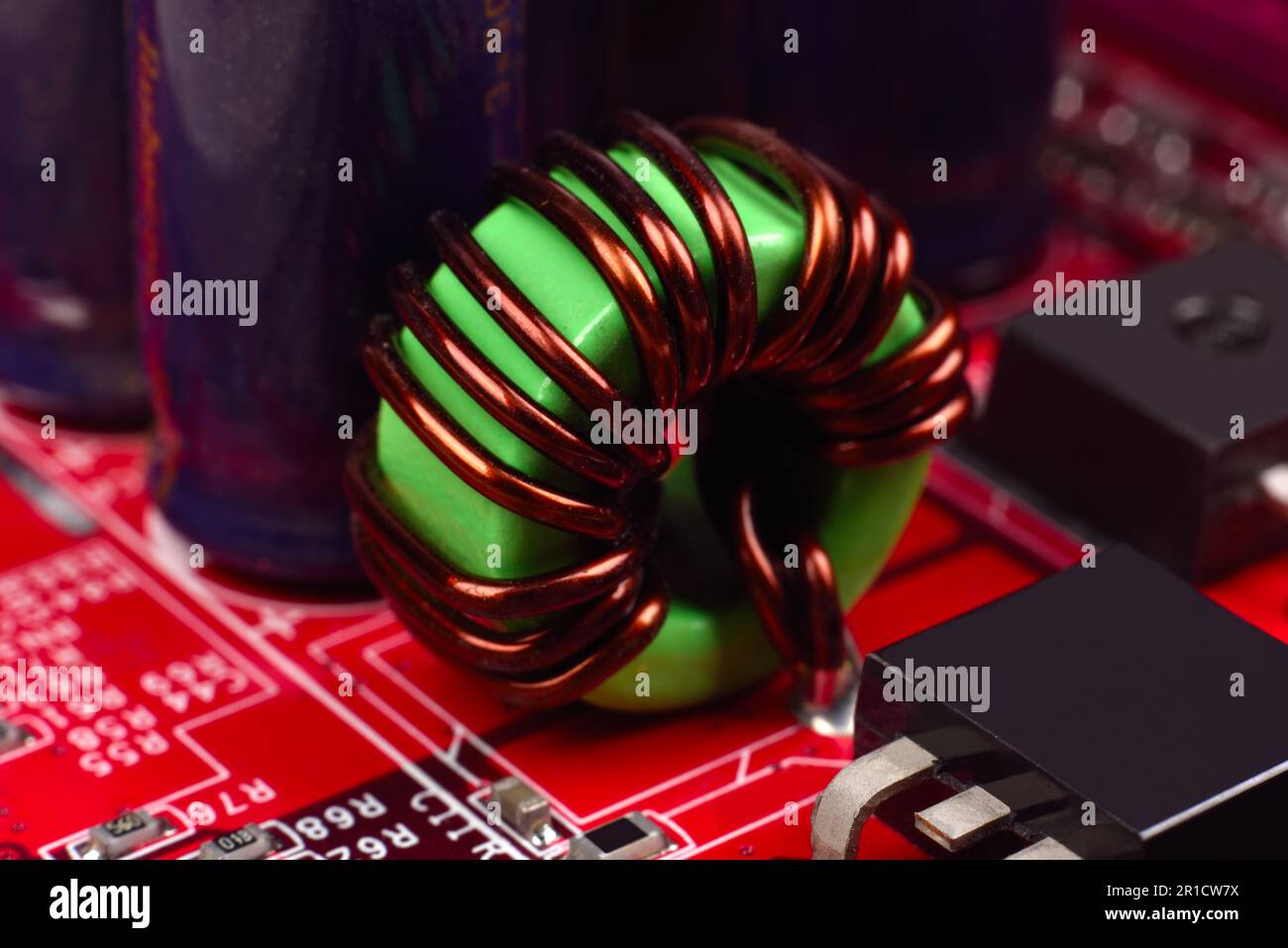 green ferrite ring on purple circuit board, close up Stock Photo - Alamy