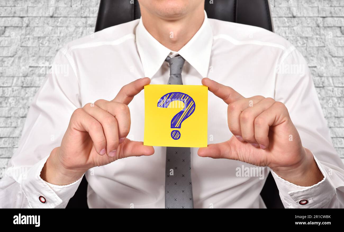 businessman holding yellow paper with question mark symbol Stock Photo ...
