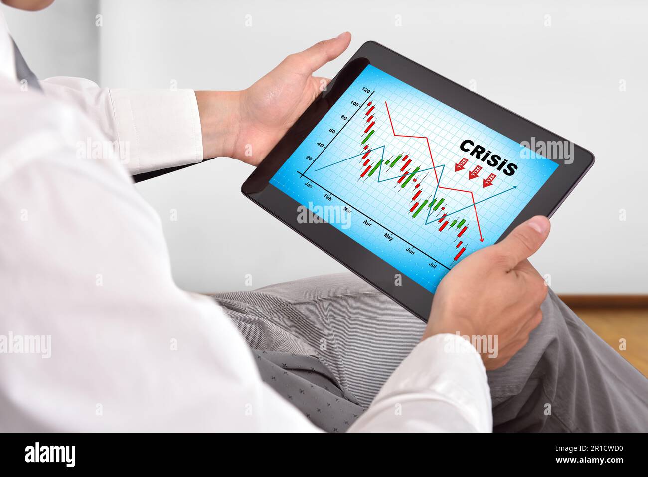 businessman holding digital touch pad with crisis chart Stock Photo - Alamy