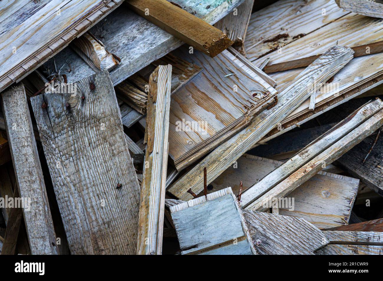 Pile of old timber wood on a backyard. Sawn old boards for firewood ...