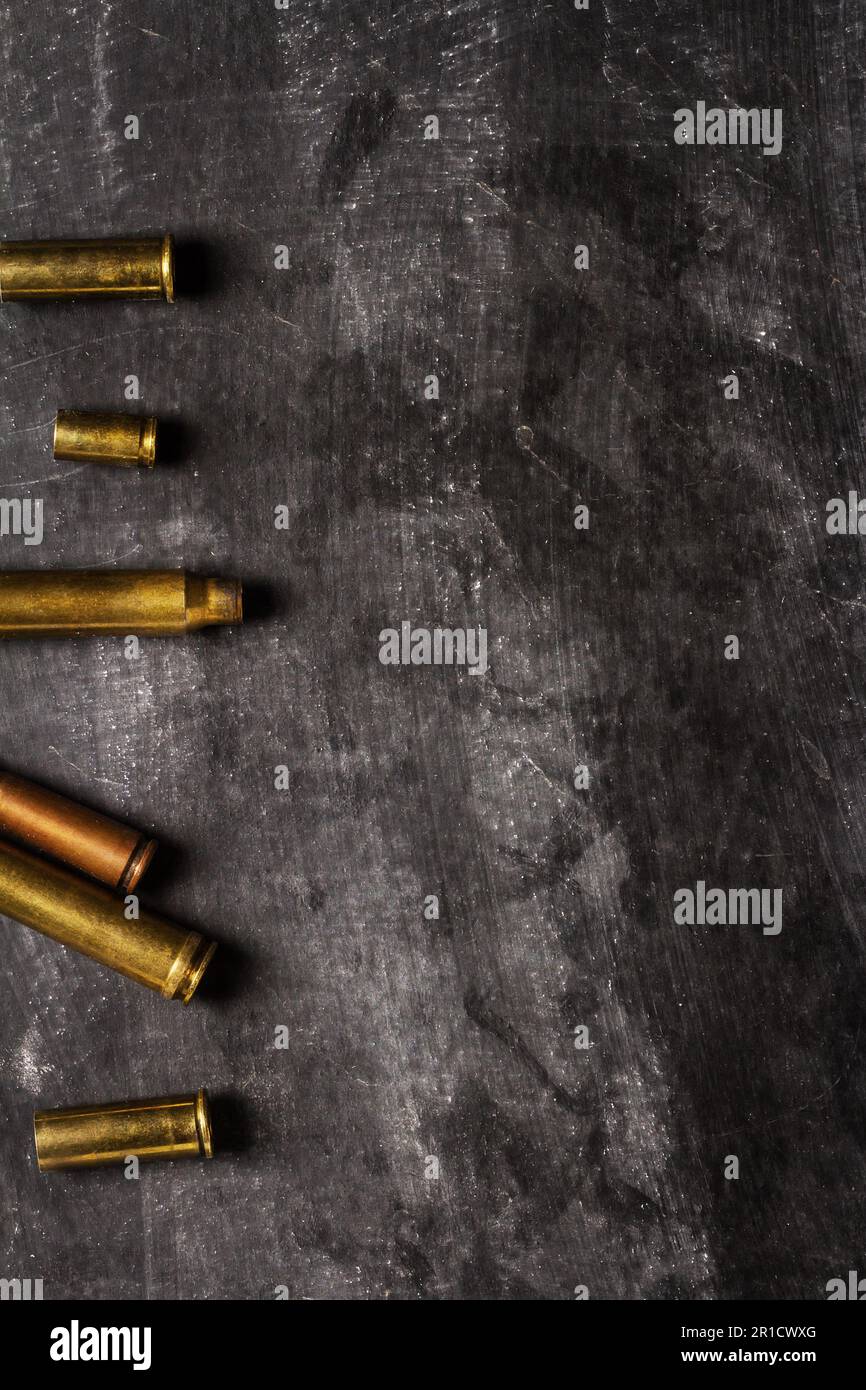 Empty bullet cartridges lying on the black background Stock Photo - Alamy