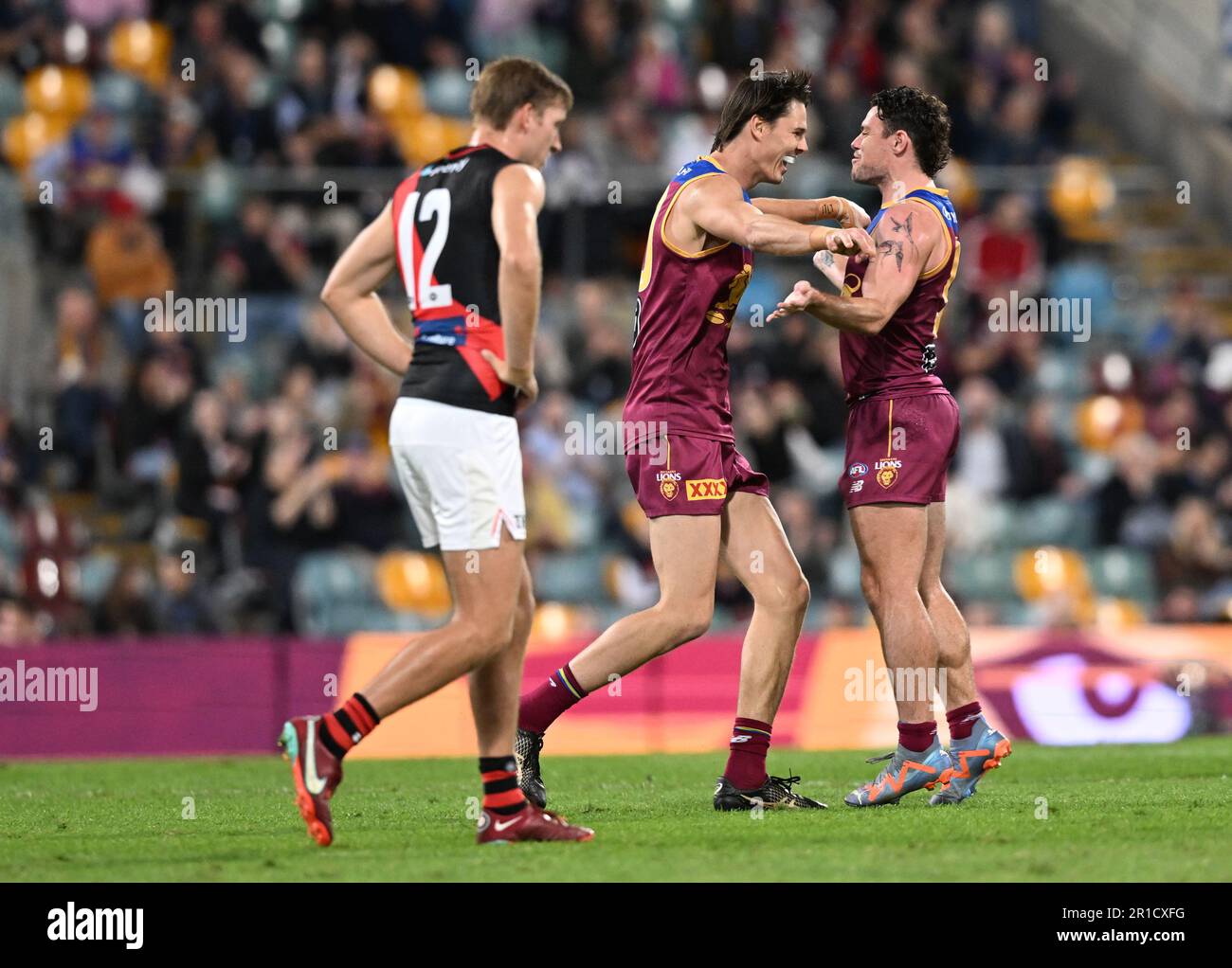 Eric Hipwood (centre) of the Lions celebrates kicking a goal with ...