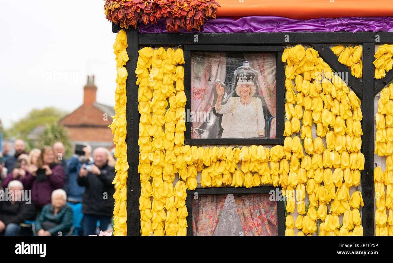 A float decorated with tulip heads featuring Queen Camilla as the ...