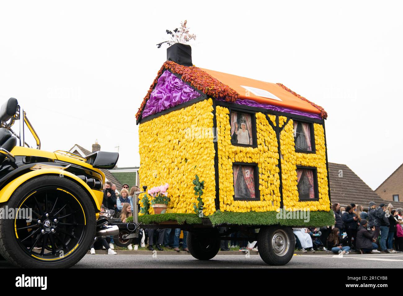 A float decorated with tulip heads featuring Queen Camilla as the ...