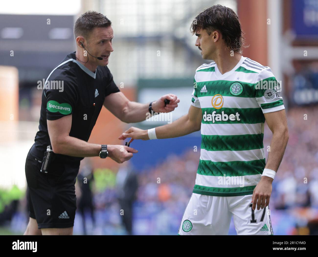 Celtic's Jota (right) hands objects to the referee Steven McLean after ...