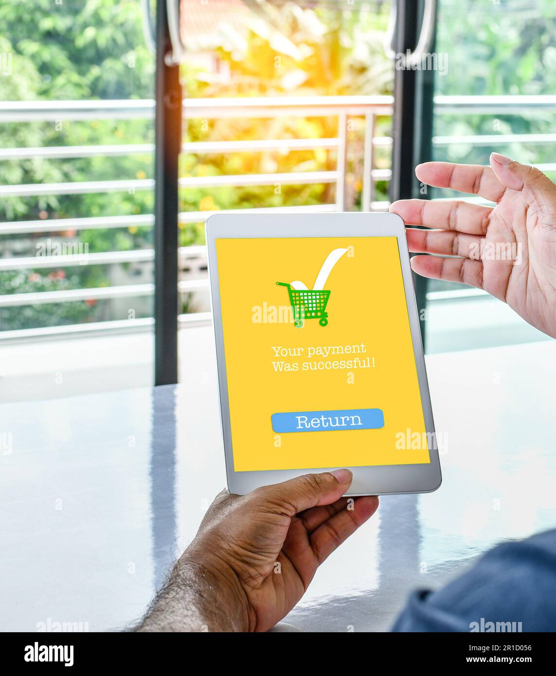 The tablet screen displays a Your payment Was successful message to ...