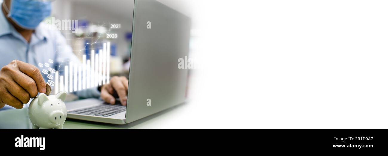 Closeup a man holding collecting coins to the white piggy bank. Concept ...