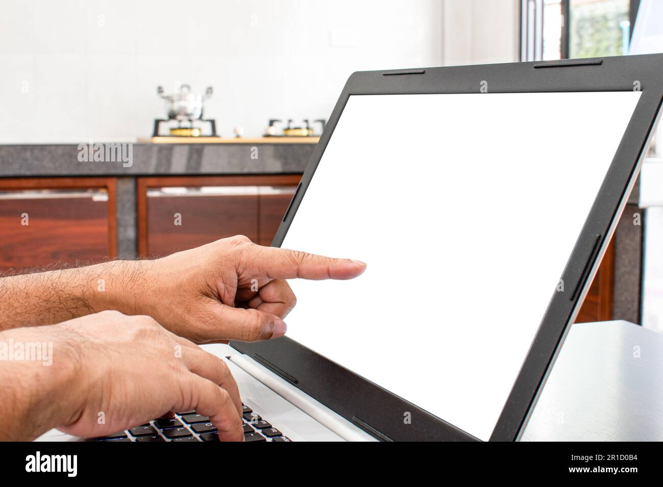 Closeup, A man's hand is a touch on a laptop blank screen to search out ...