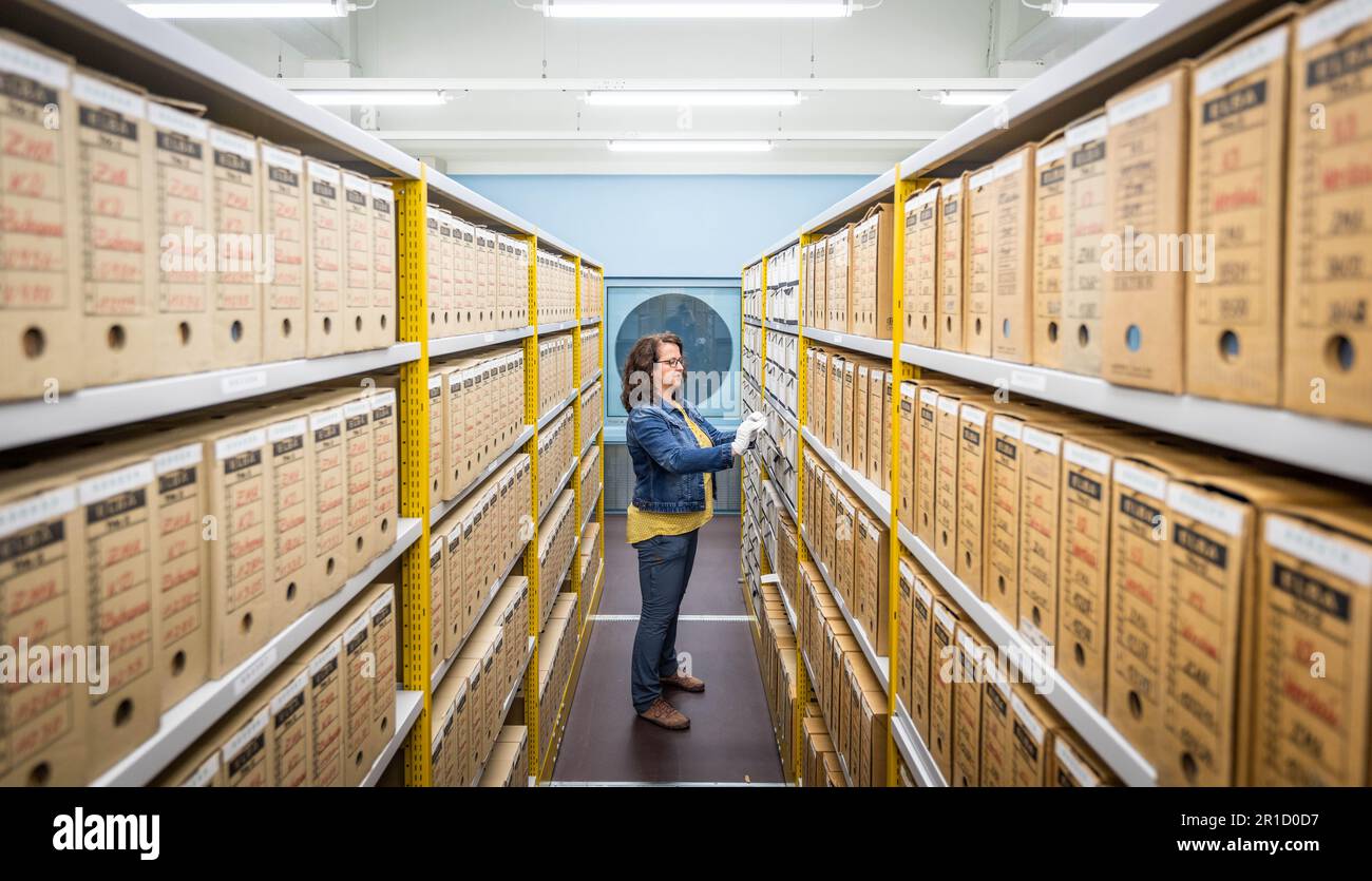 13 May 2023, Saxony, Chemnitz: Archivist Anja Schmaal digs out files ...