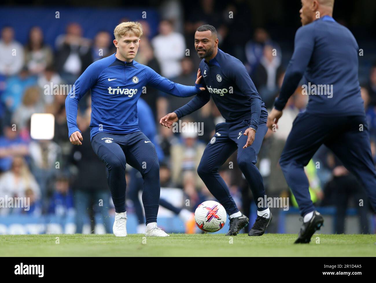Chelsea's Lewis Hall (left) with Chelsea coach Ashley Cole on the pitch ...