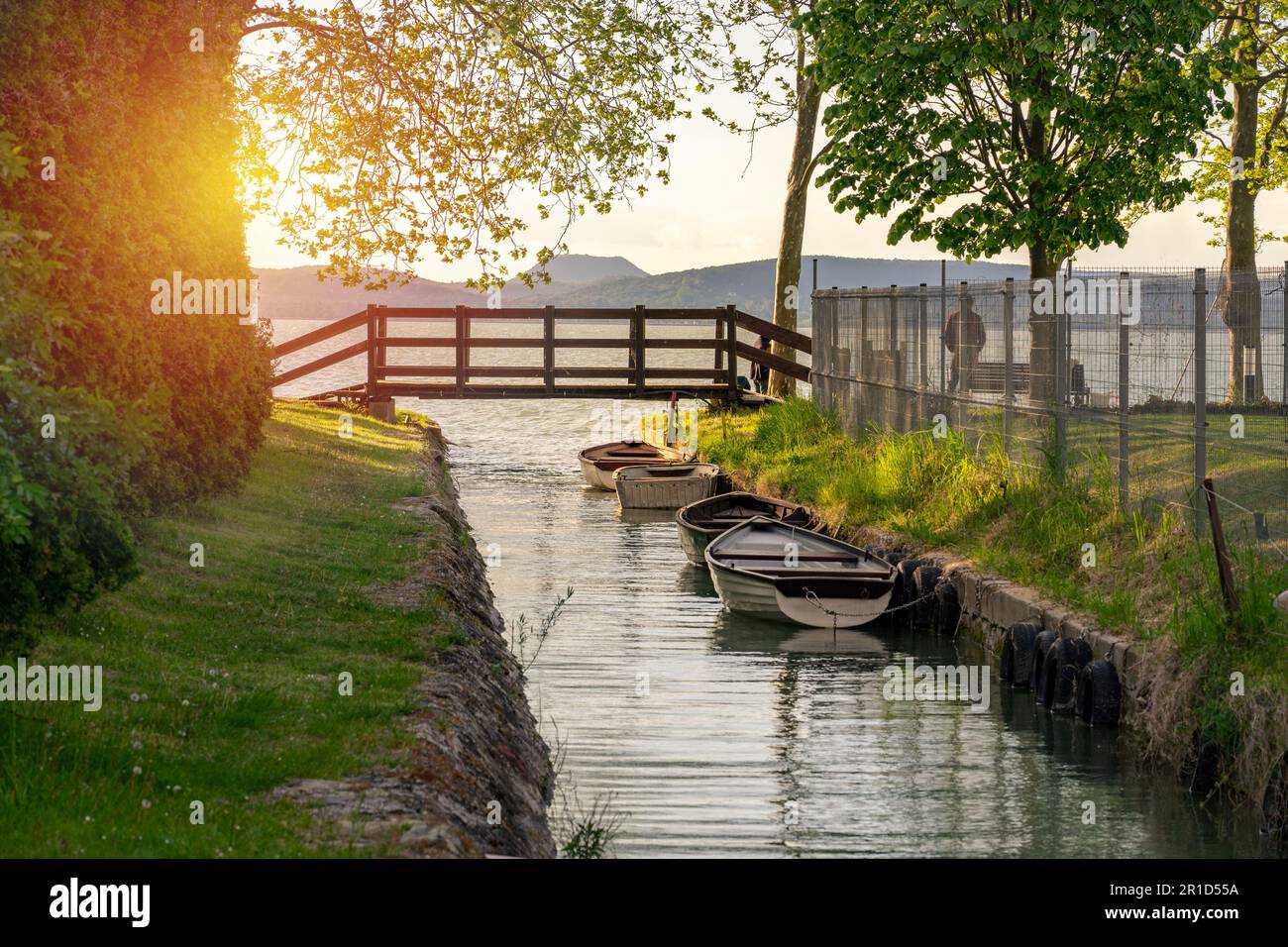 nice bridge with a small canal in Balatonbolar and fishng boats next to ...