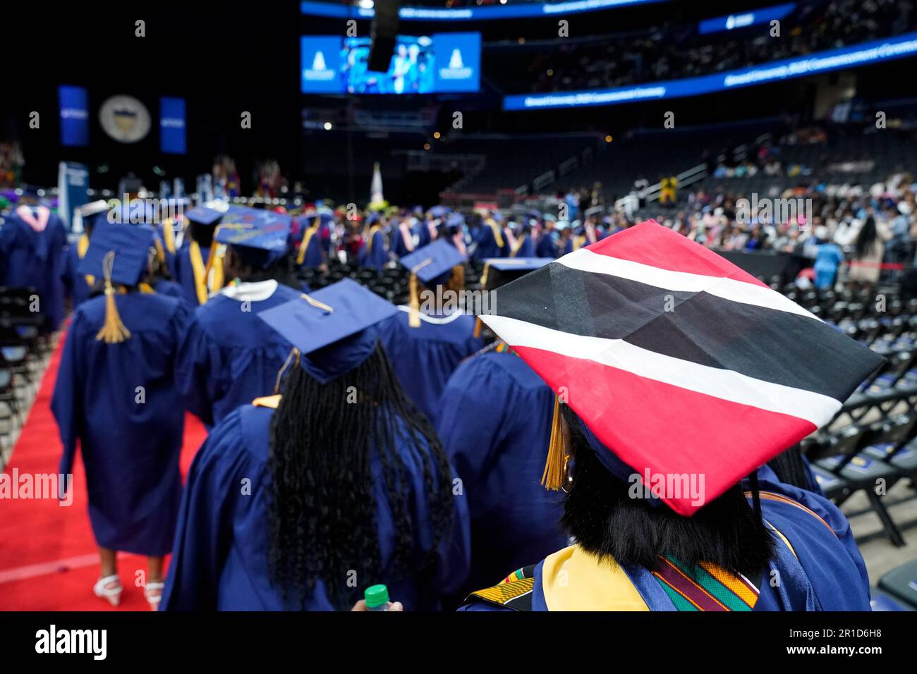 A graduate wears a cap decorated with the flag of Trinidad and Tobago ...