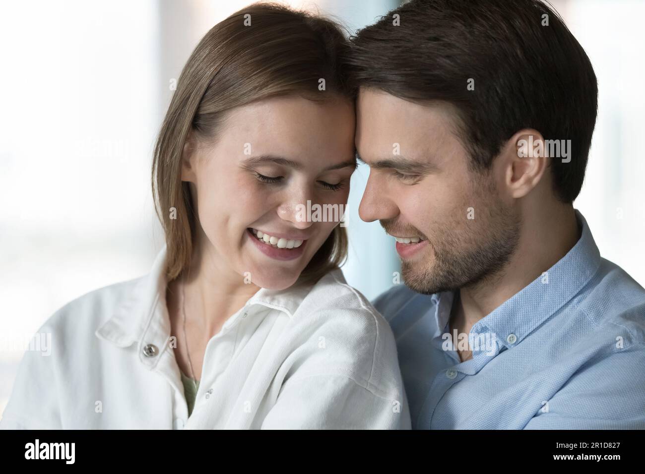 Happy attractive young dating married couple in love standing close ...
