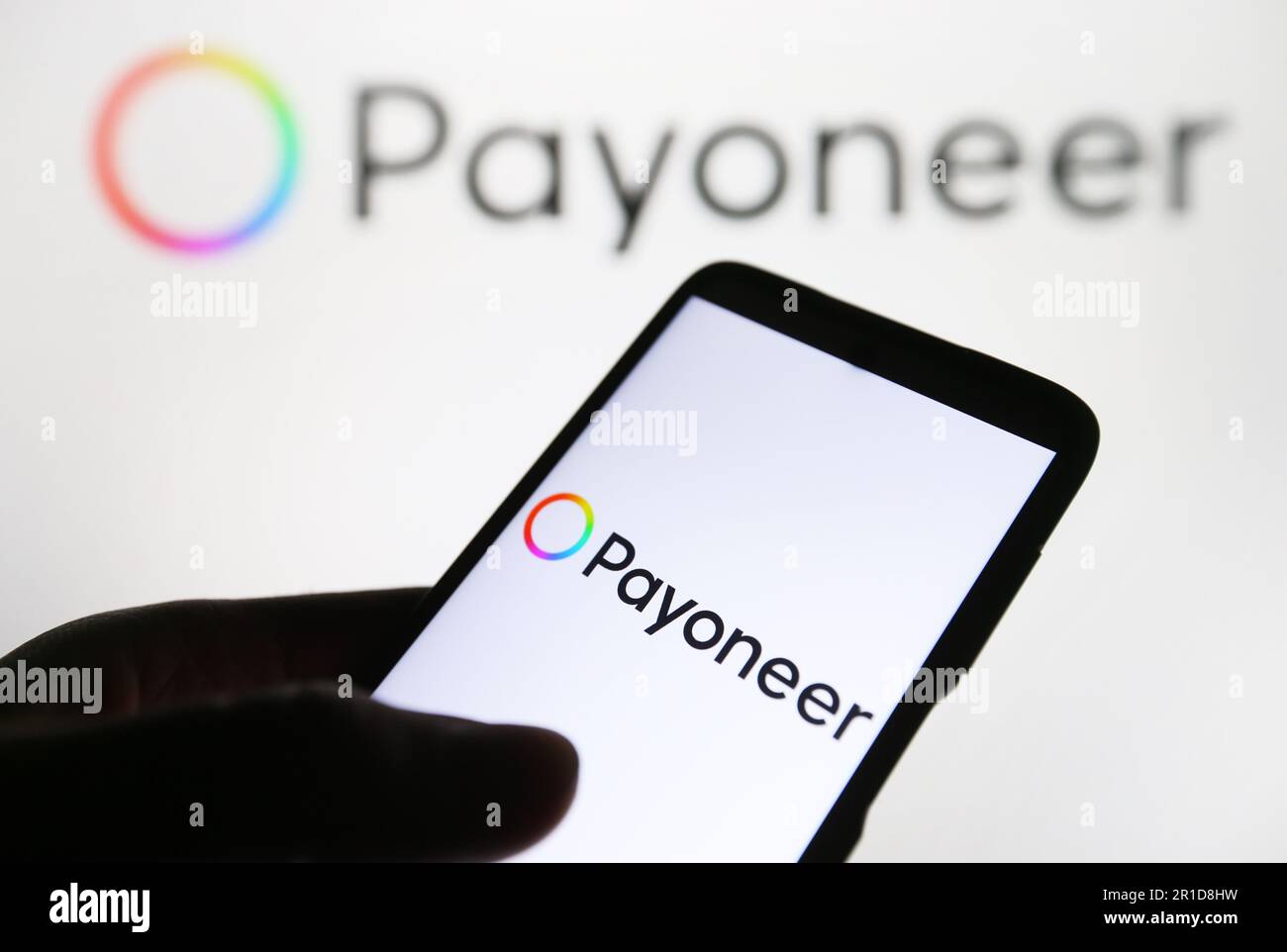 In this photo illustration, a Payoneer logo is seen on a smartphone and ...