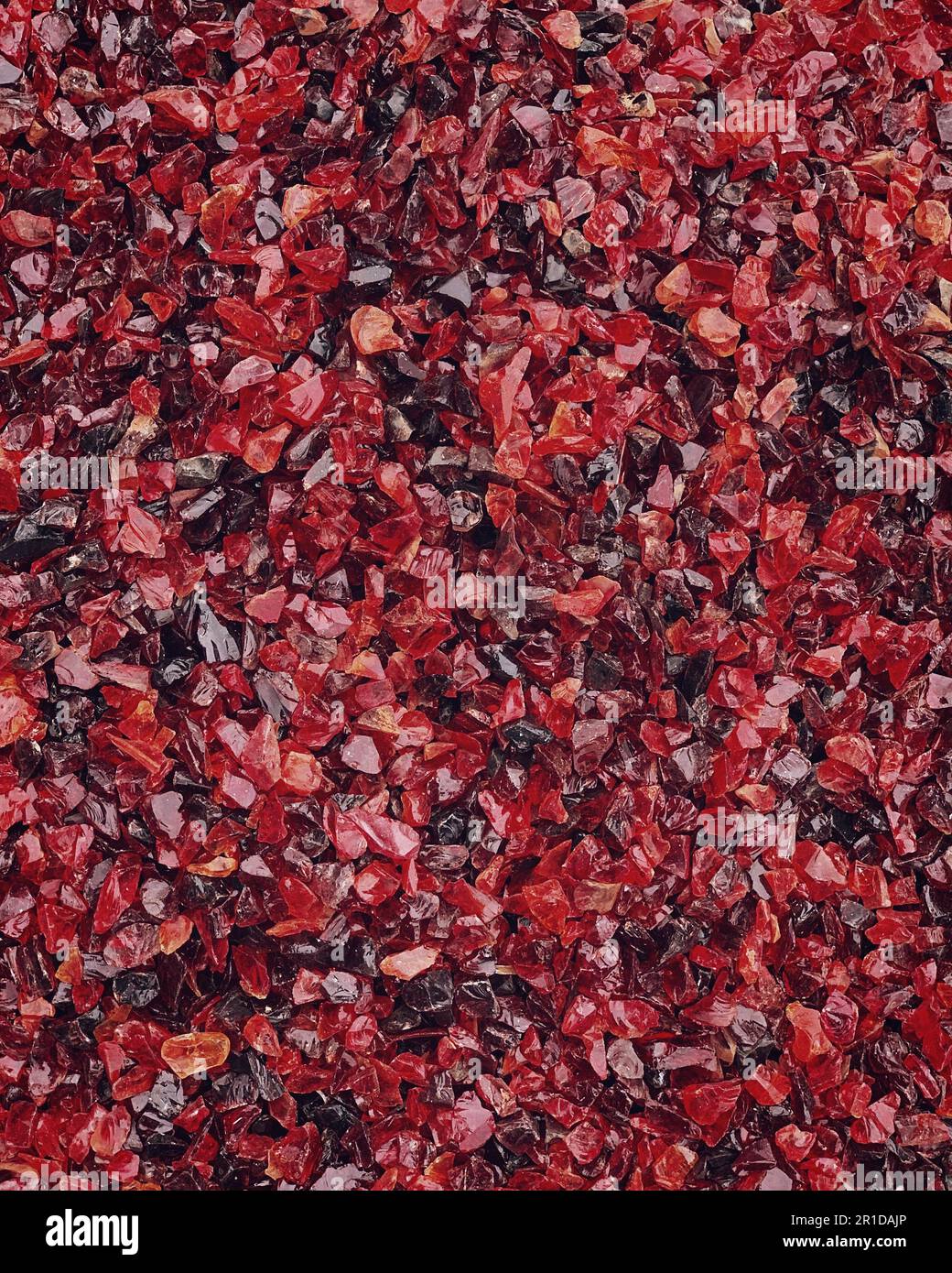 A top view of red glass ruby-colored stones and aggregate material ...