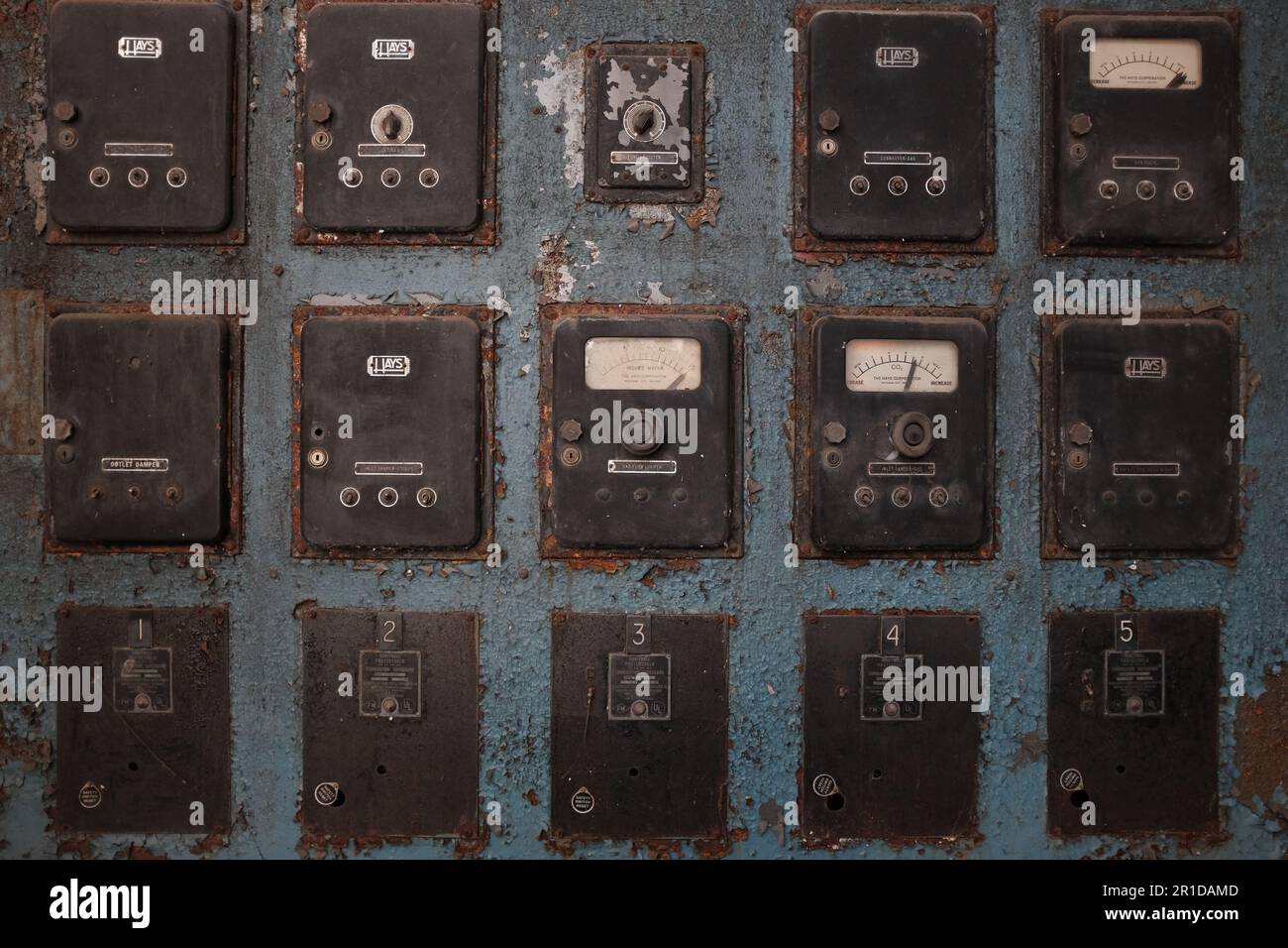 An old switchboard covered in various electrical components, with wires ...