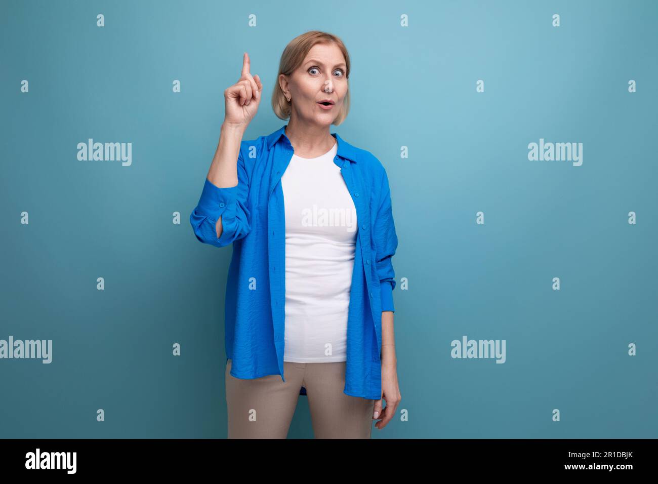 smart mature woman thinking brilliant idea on blue background with ...