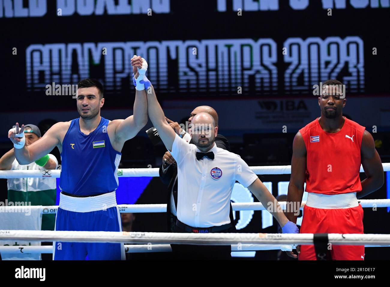 A referee holds up Uzbekistan's Bakhodir Jalolov hand, as he is ...