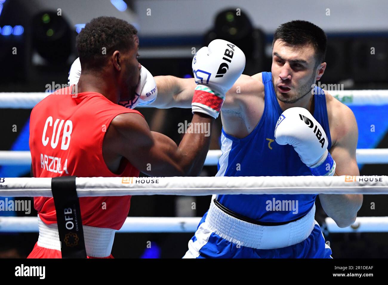 Uzbekistan's Bakhodir Jalolov, blue, fights with Cuba's Fernando Arzola ...