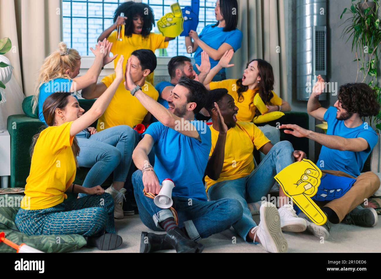 YES. Multiethnic sports fans laughing, giving five, screaming and fist ...