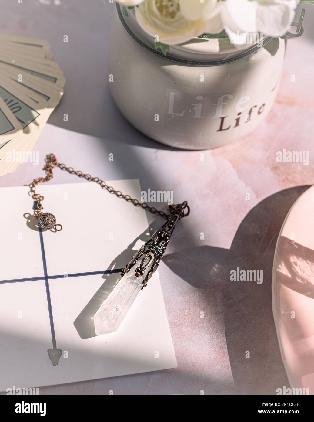 Gemstones for esoteric spiritual practice. Rock crystal pendulum on the ...